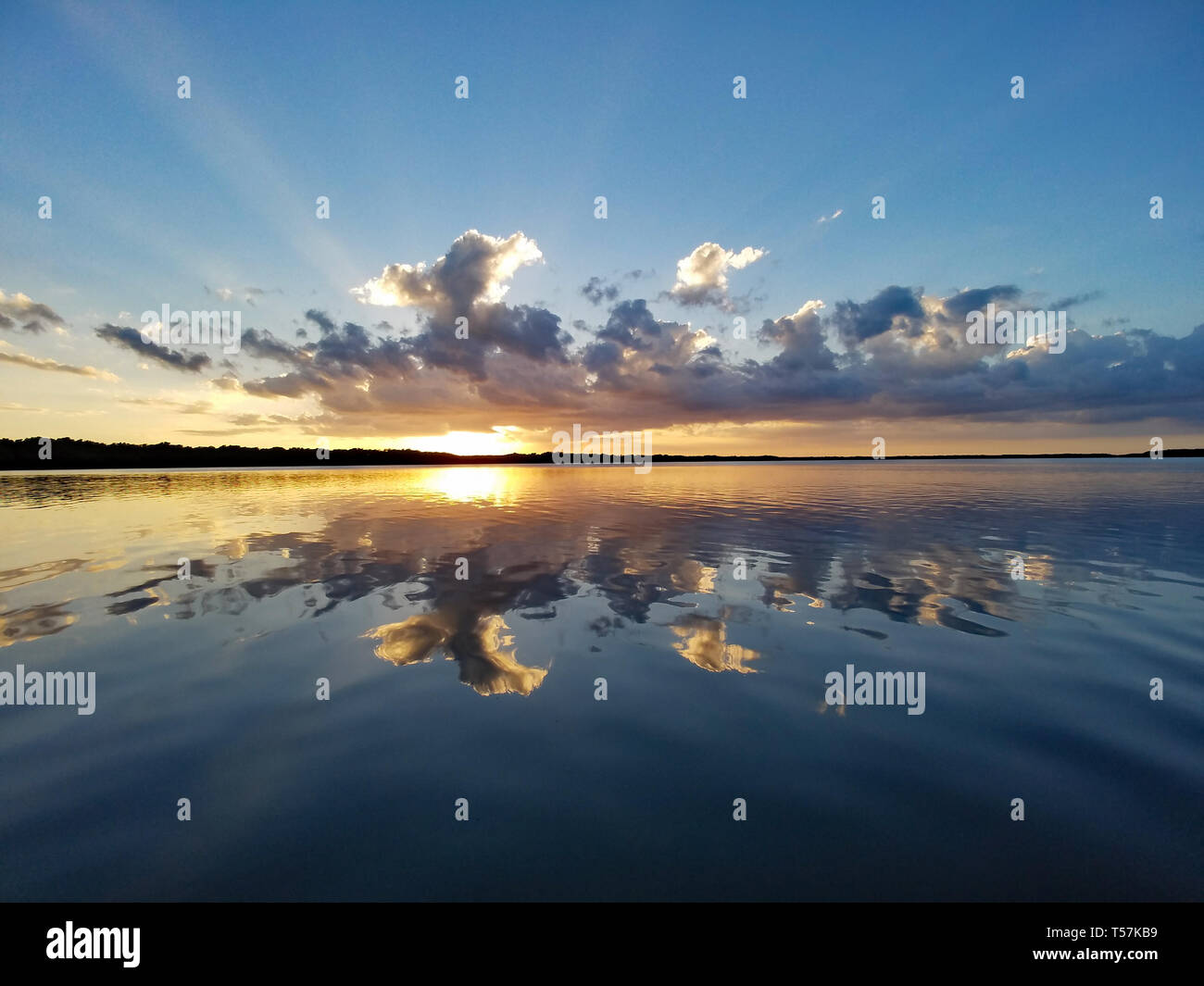 Sunset and cloudscape reflected on the tranquil water of Coot Bay in ...