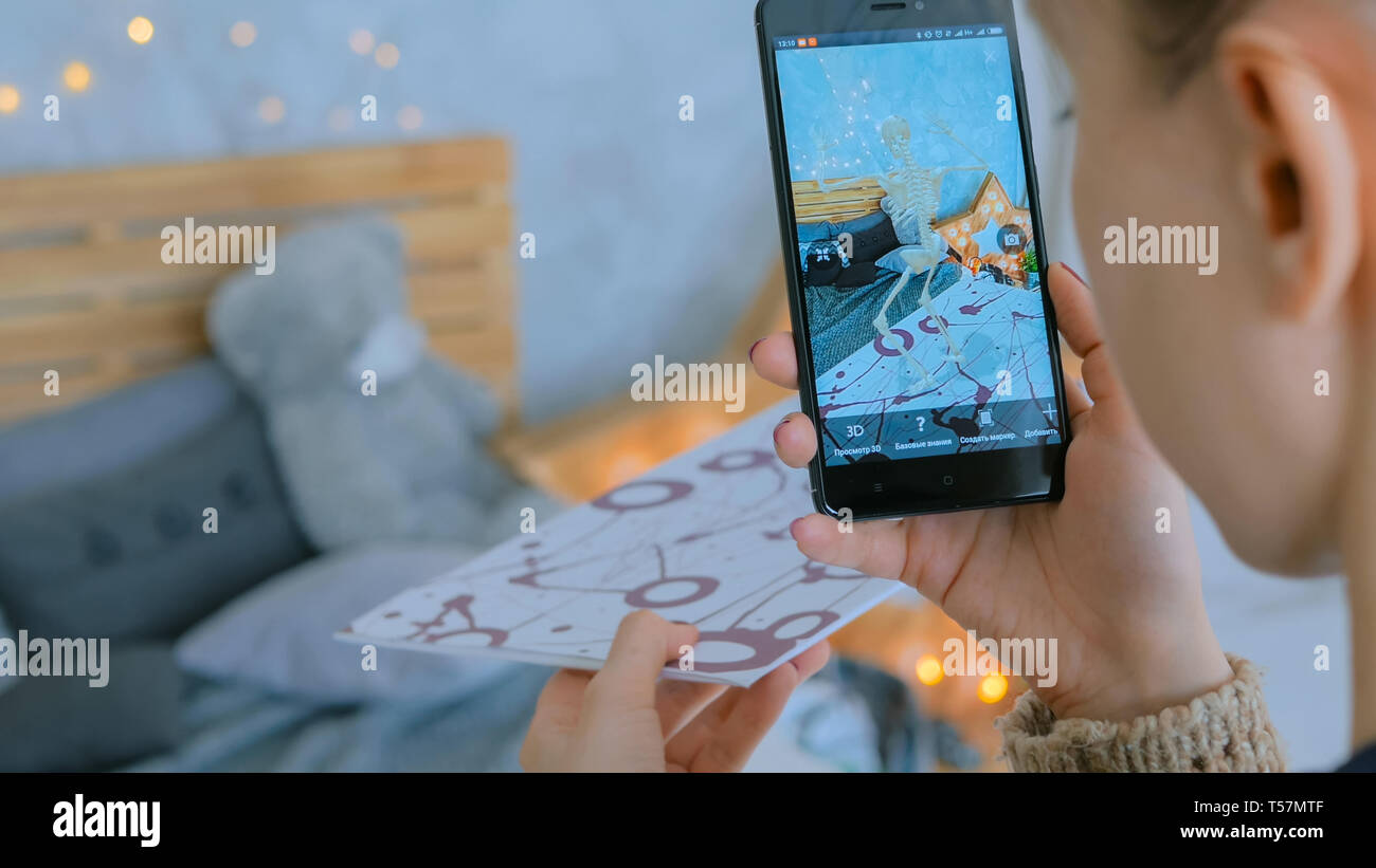 MOSCOW, RUSSIA - AUGUST 10, 2018. Woman using smartphone with augmented ...