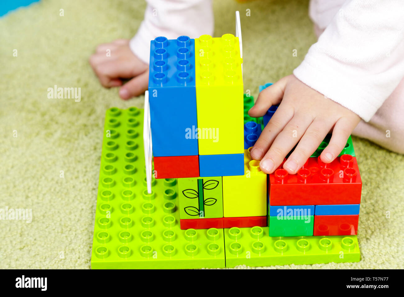 Children plastic color bricks with children hand. close up Stock Photo ...