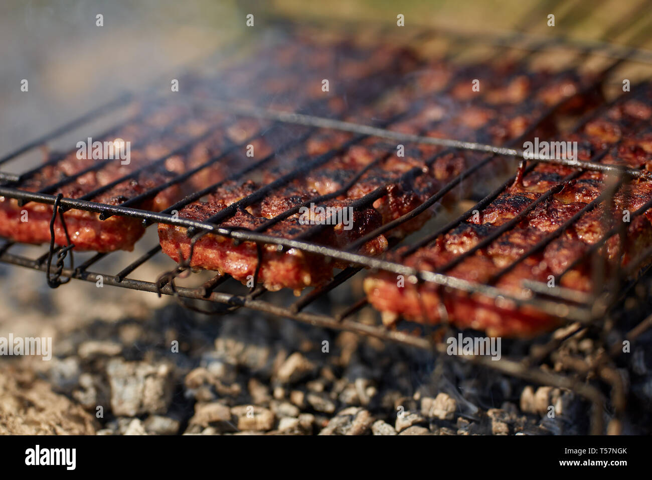 Meat rolls being grilled outdoor in the countryside Stock Photo - Alamy