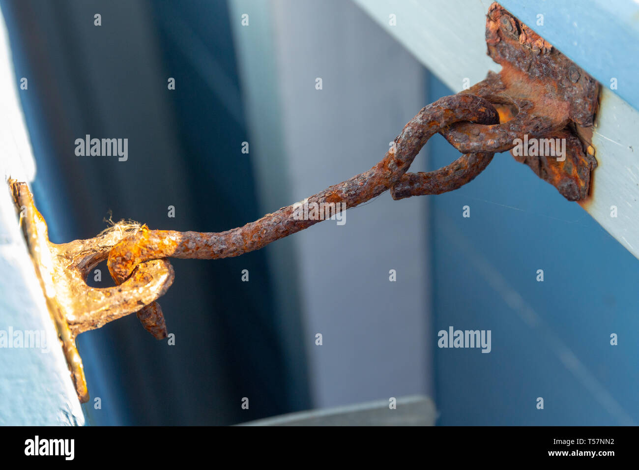 Rusty hook and latch on a wooden door Stock Photo - Alamy