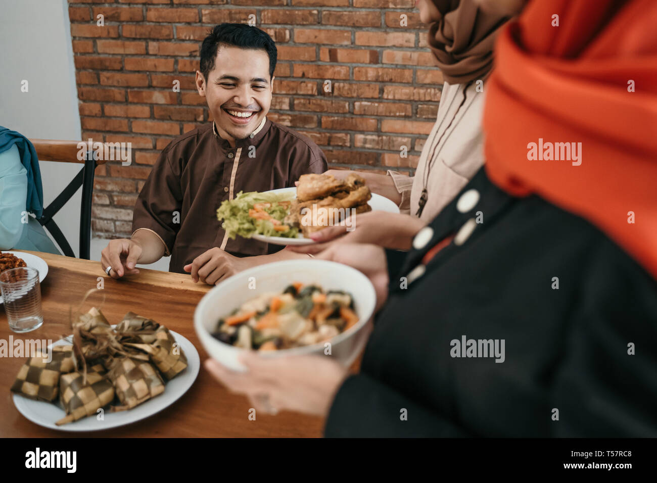 muslim male being served with food for break fasting Stock Photo - Alamy