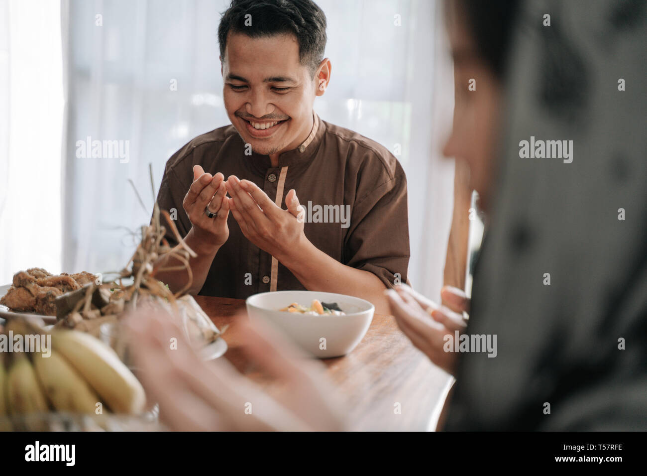 muslim man open his arm and pray before eat Stock Photo - Alamy