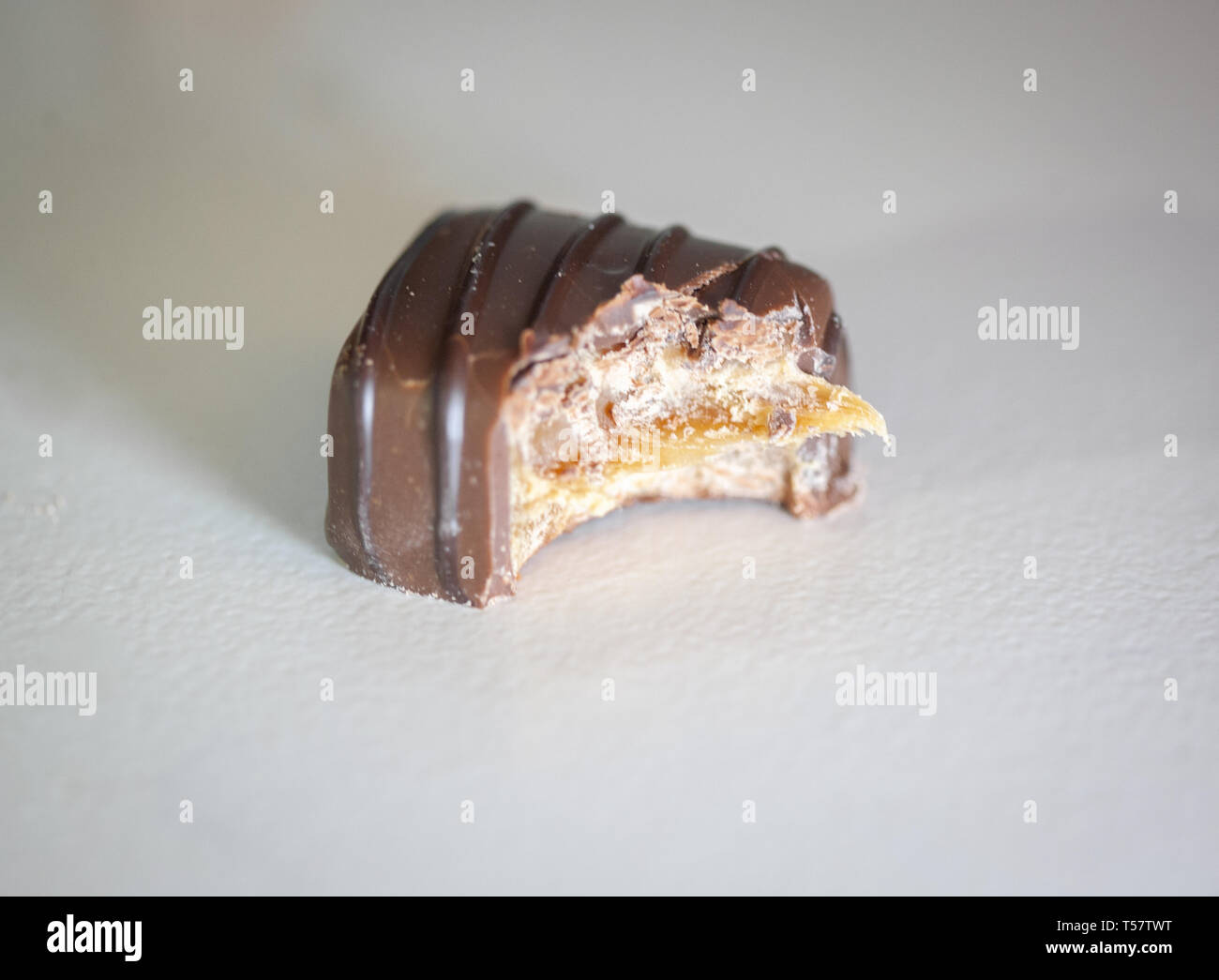 Chocolate candy with a bite out of it Stock Photo - Alamy