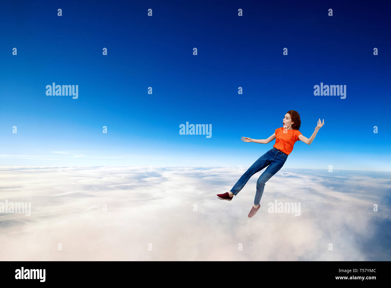 Young redhead woman failed and falling down in clouds sea Stock Photo ...