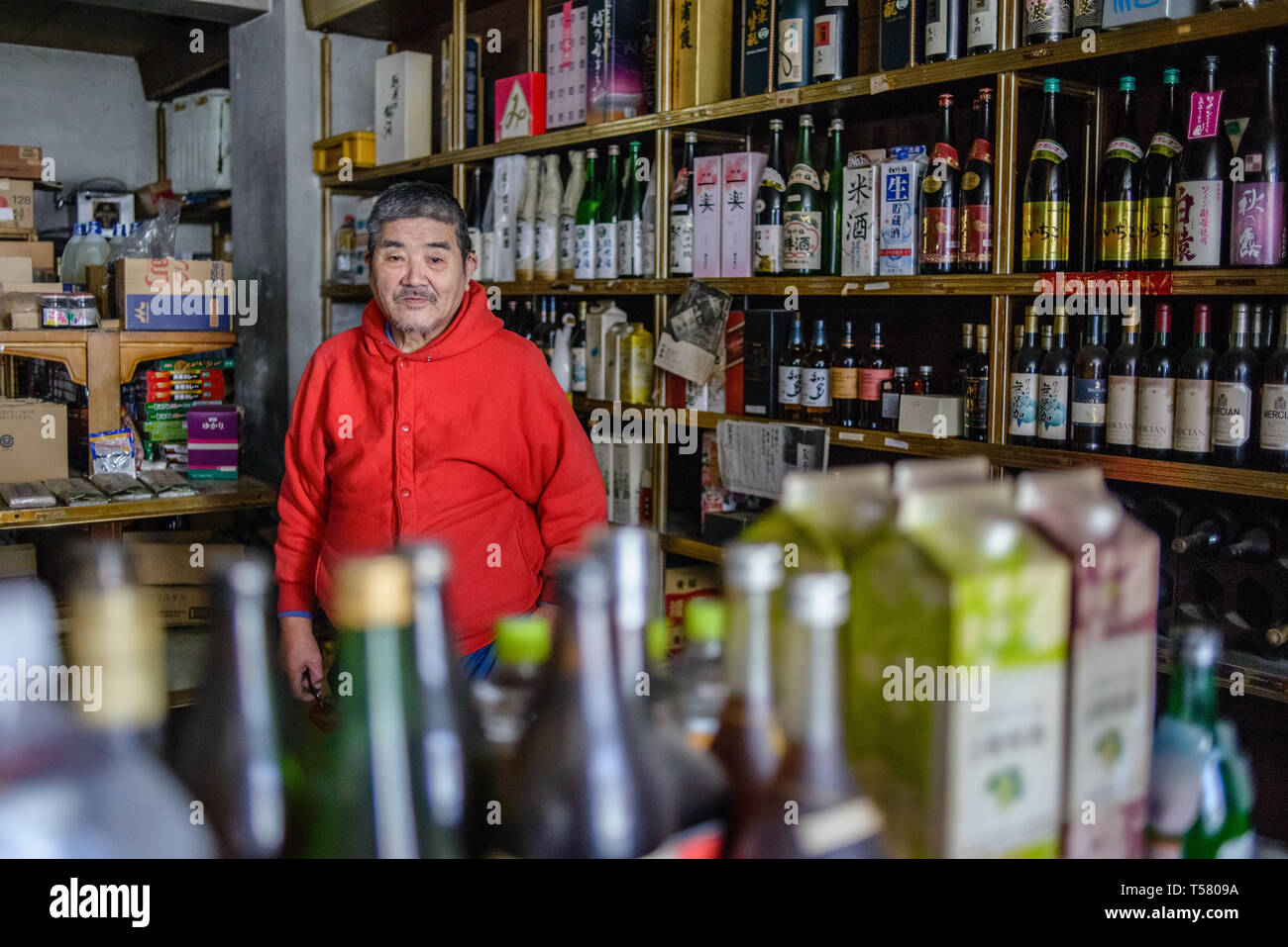 Portrait of the owner of a traditional Japanese liquor store and ...