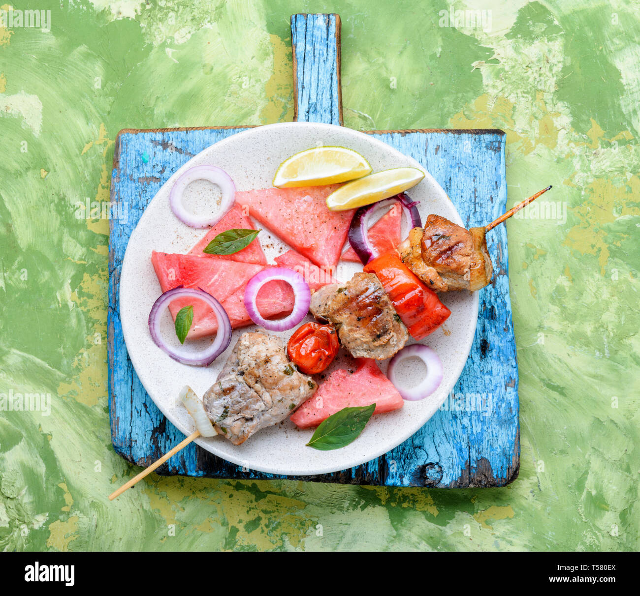 Skewers of pork shish kebab.Appetizer kebab with watermelon.Eastern ...