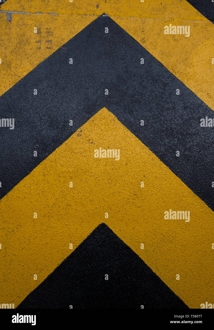 Yellow safety arrows on the ground Stock Photo - Alamy