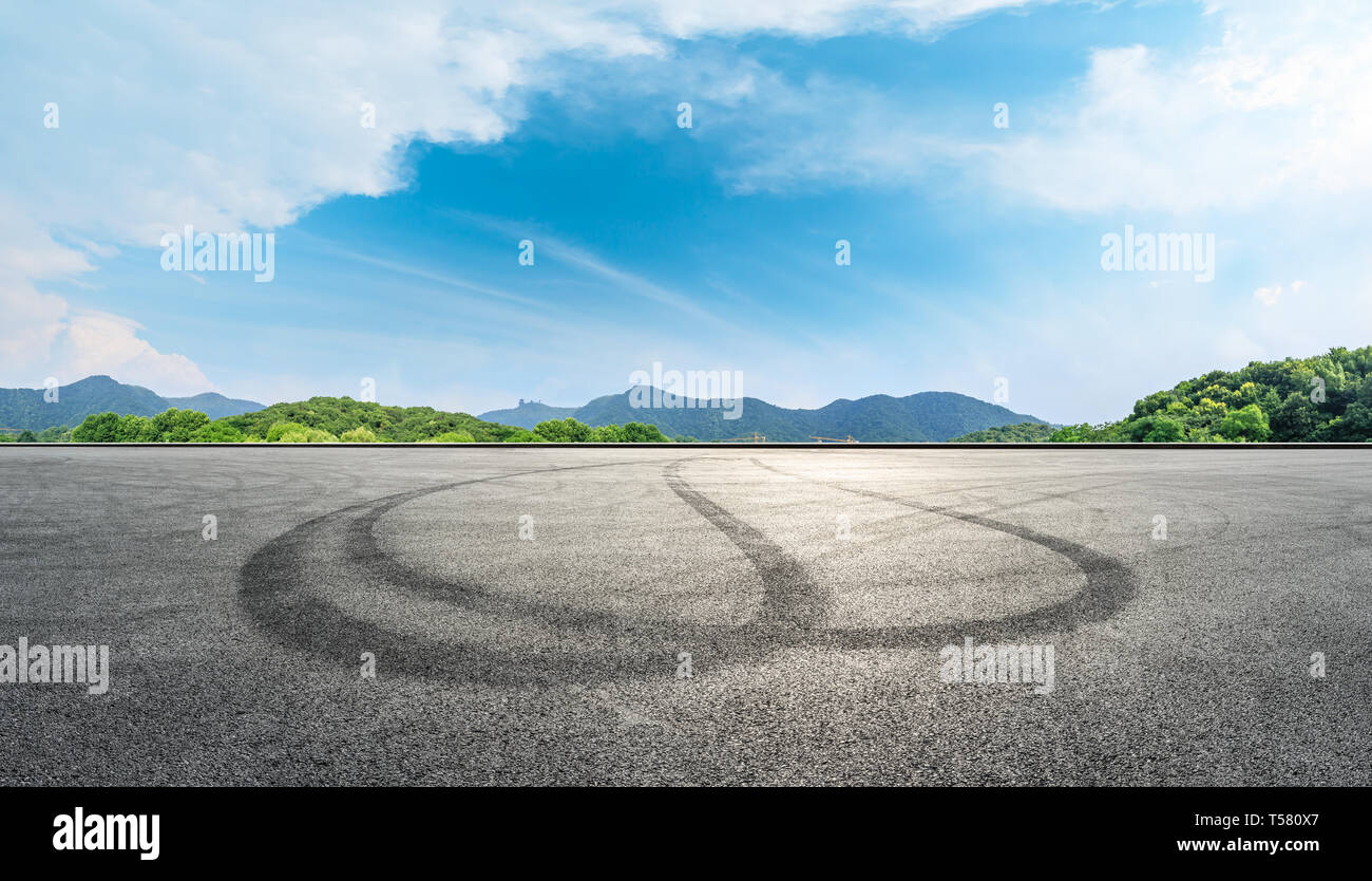 Asphalt race track ground and mountains with blue sky landscape Stock ...