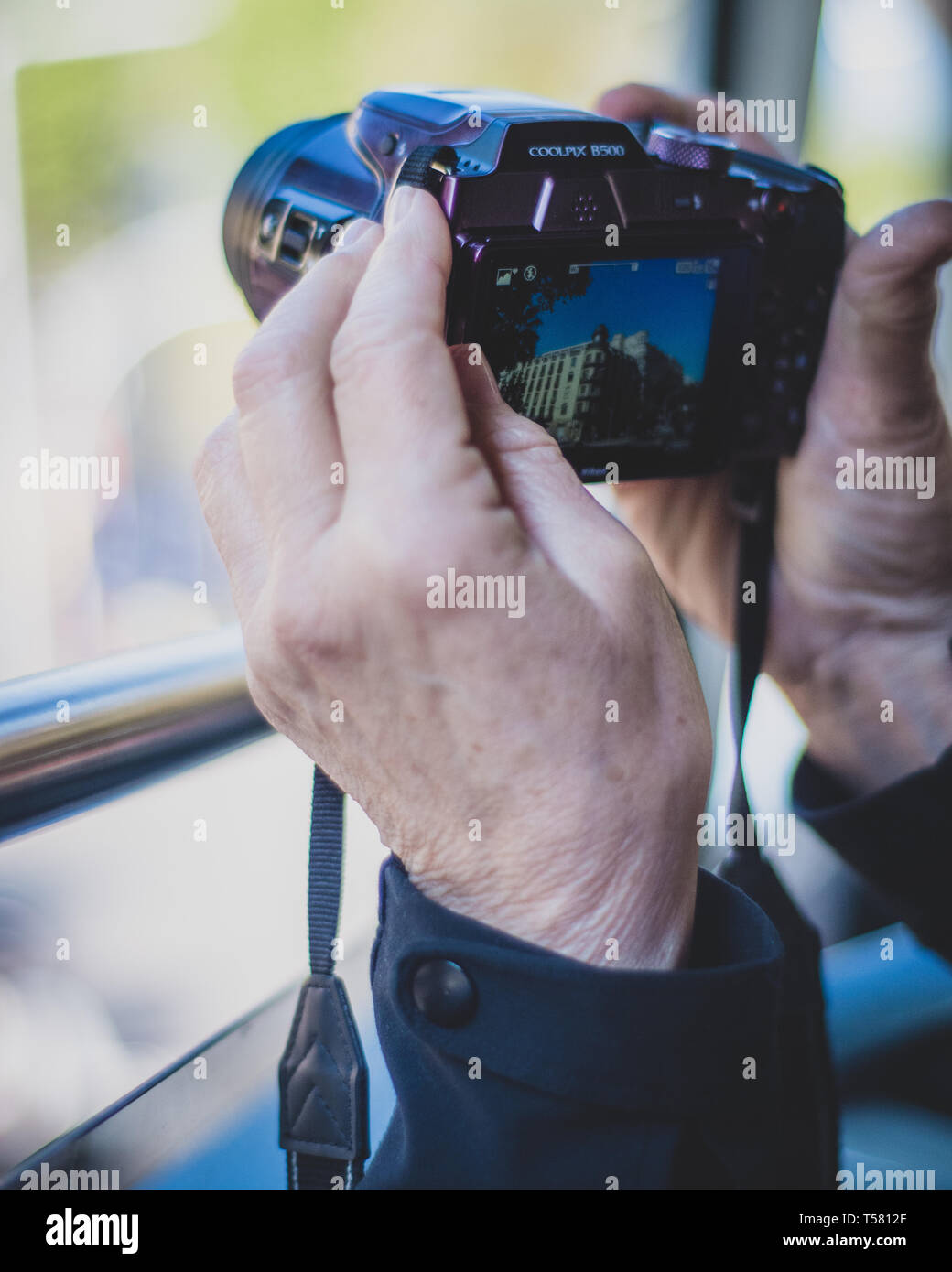 Enthusiast photographer takes a picture with his Nikon Coolpix camera ...