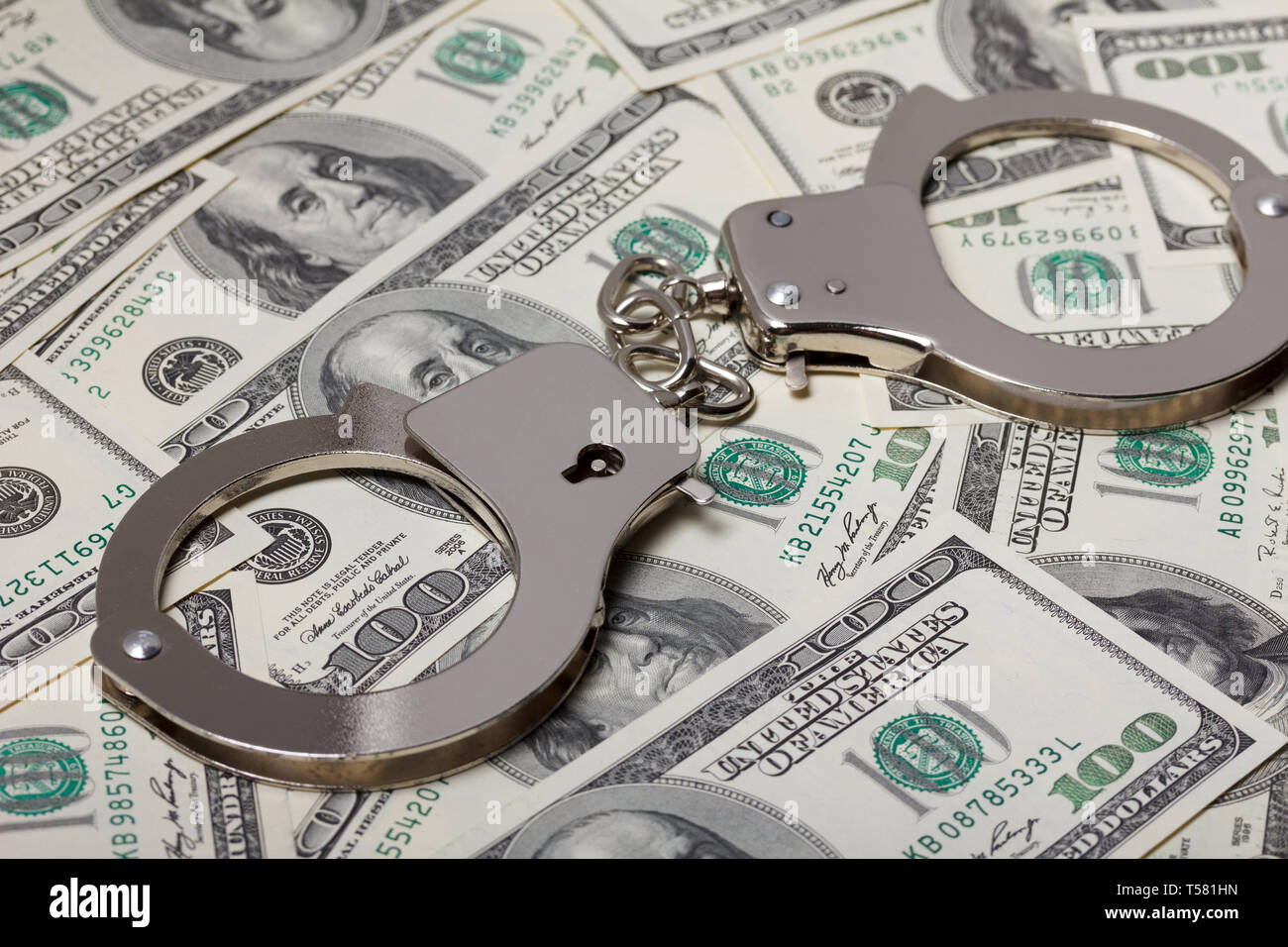 Handcuffs on money Stock Photo - Alamy