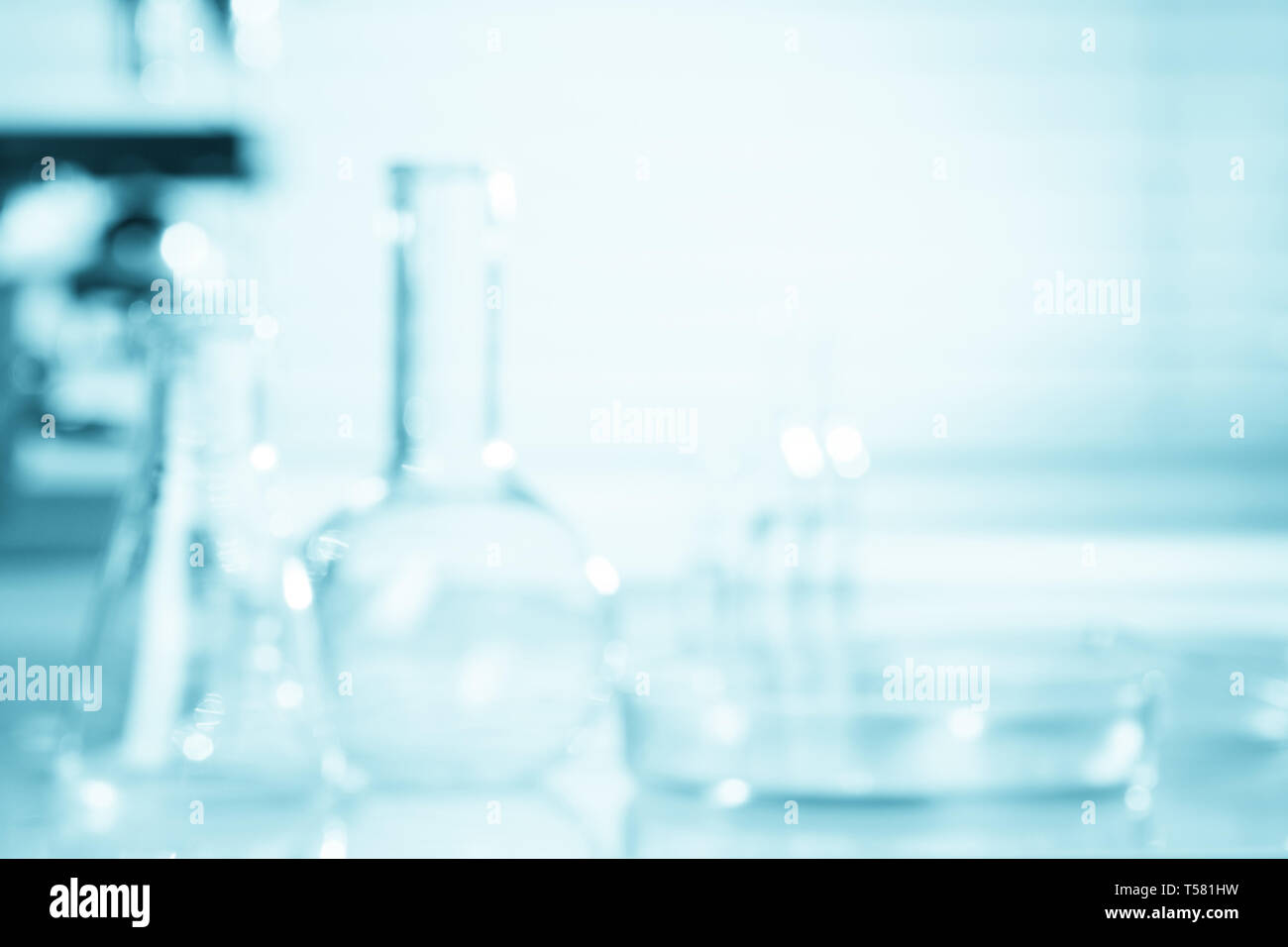 Blurred science background, test tubes and microscope with copy-space ...
