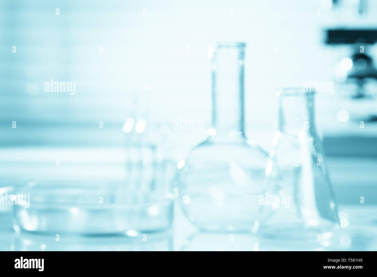 Blurred science background, test tubes and microscope, research concept ...