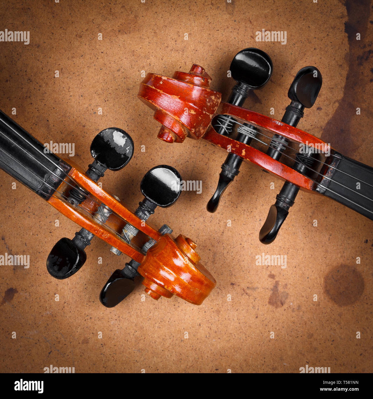 Old violin scrolls detail over grunge background Stock Photo - Alamy