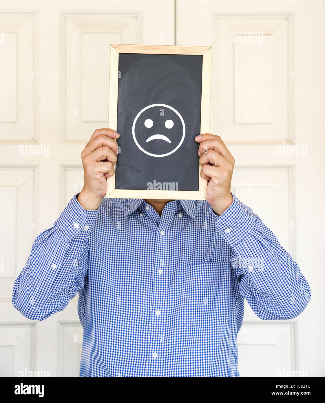 Sad unhappy face or depressed emotions concept, man had a board in ...