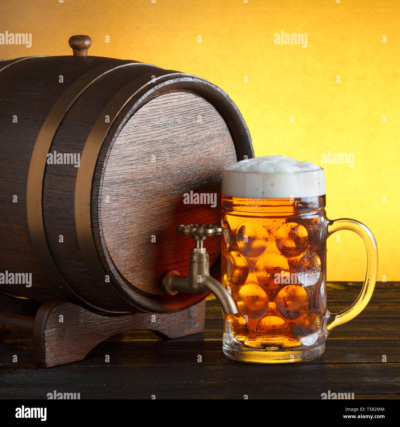 Vintage beer barrel with huge beer glass on wooden table still life ...