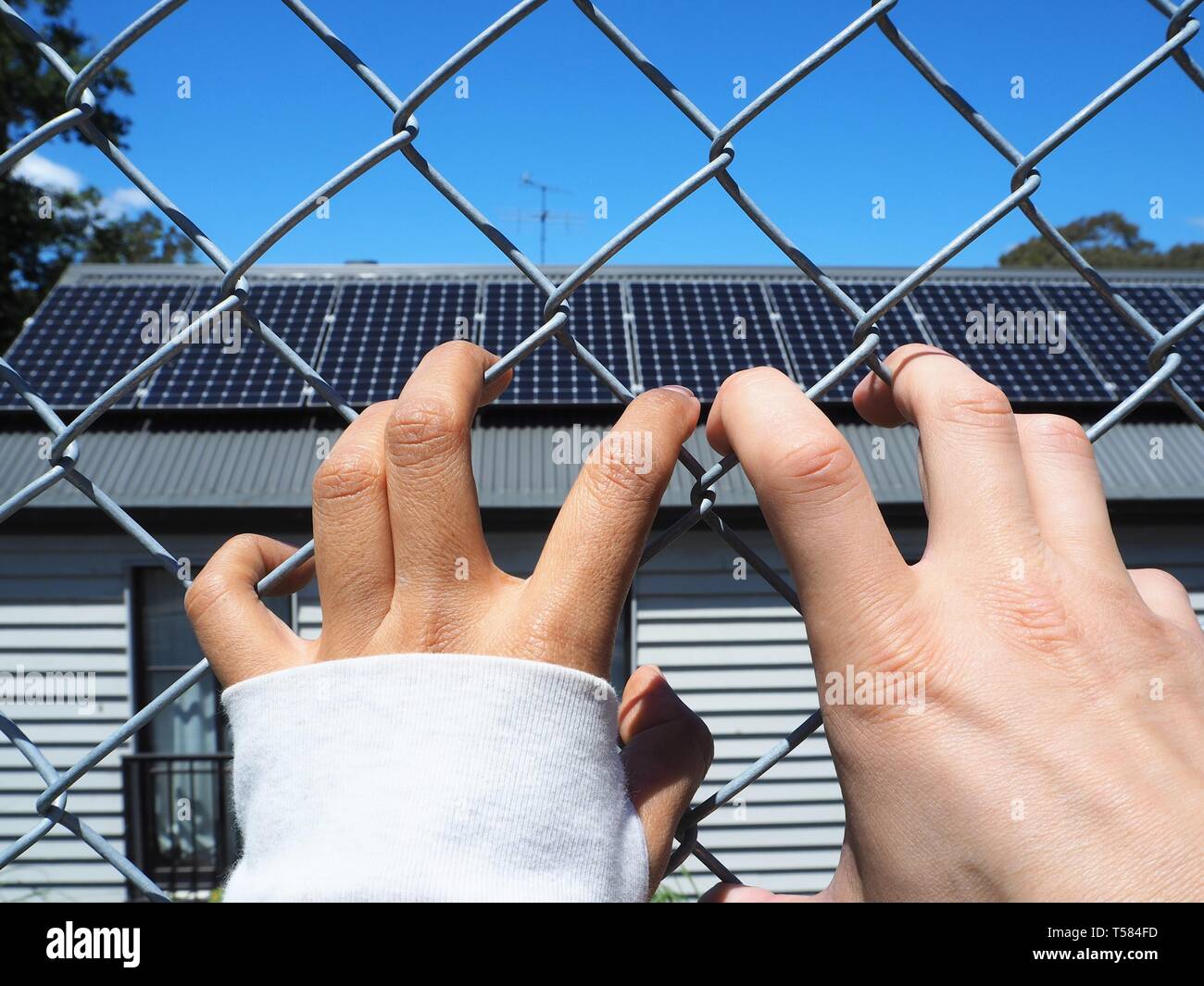 Hands wire fence hi-res stock photography and images - Alamy