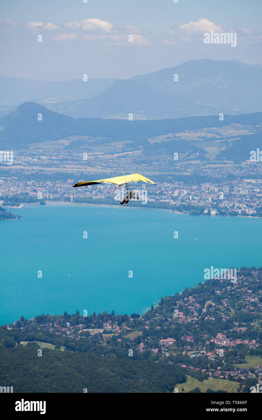 Hang-glider Instructor Flying in Hang-glider with Customer over Annecy ...