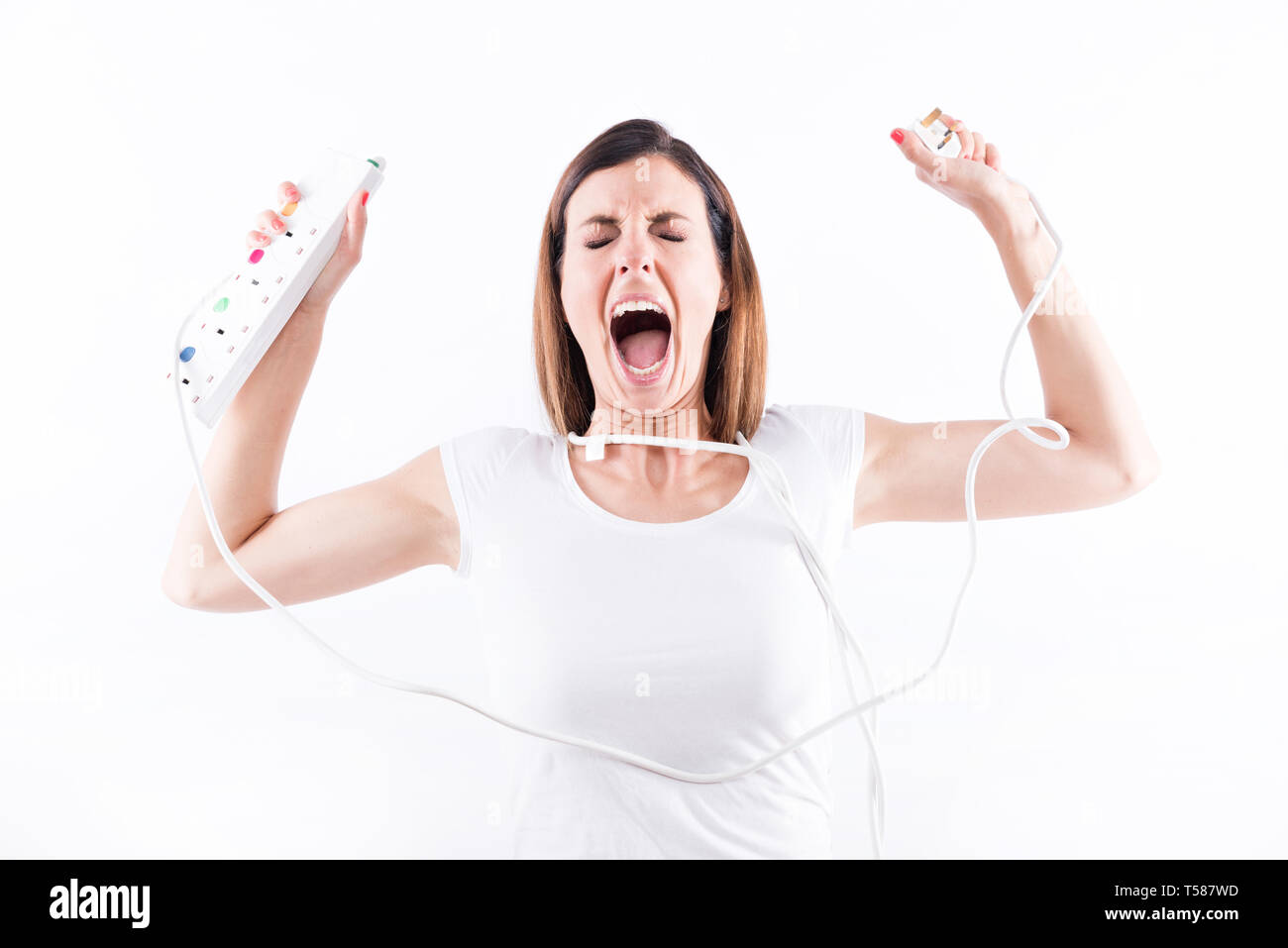 A beautiful young woman screaming with power cables in her hands Stock ...