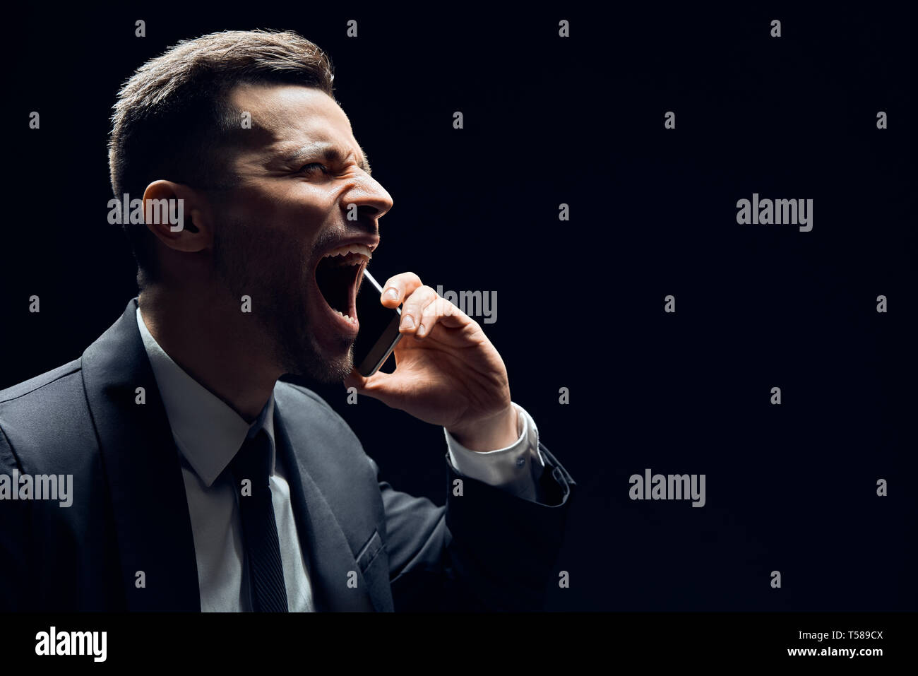 Angry man screaming talking on mobile phone with copy space isolated on ...