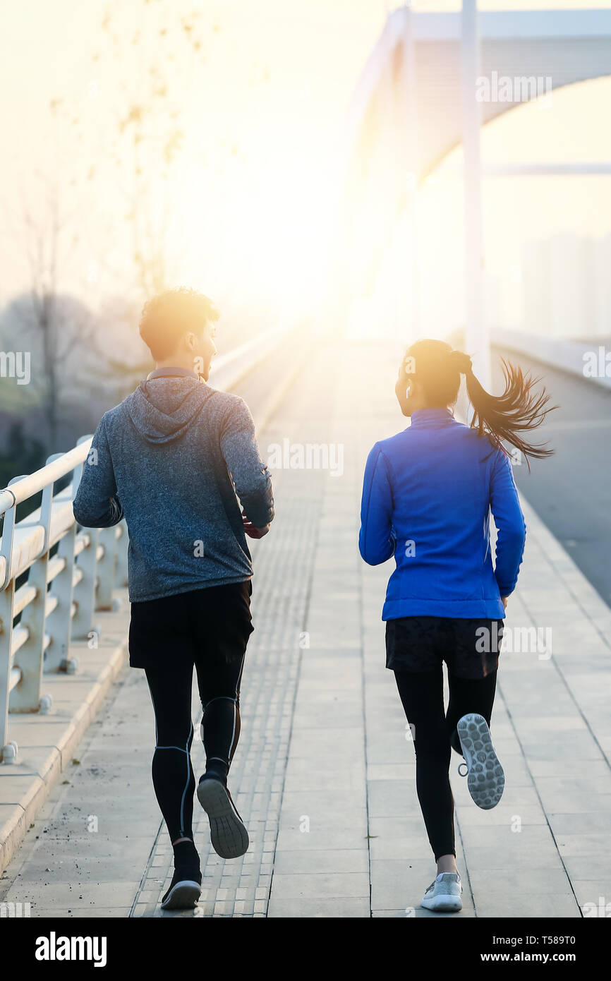 Young couples outdoor jogging Stock Photo - Alamy