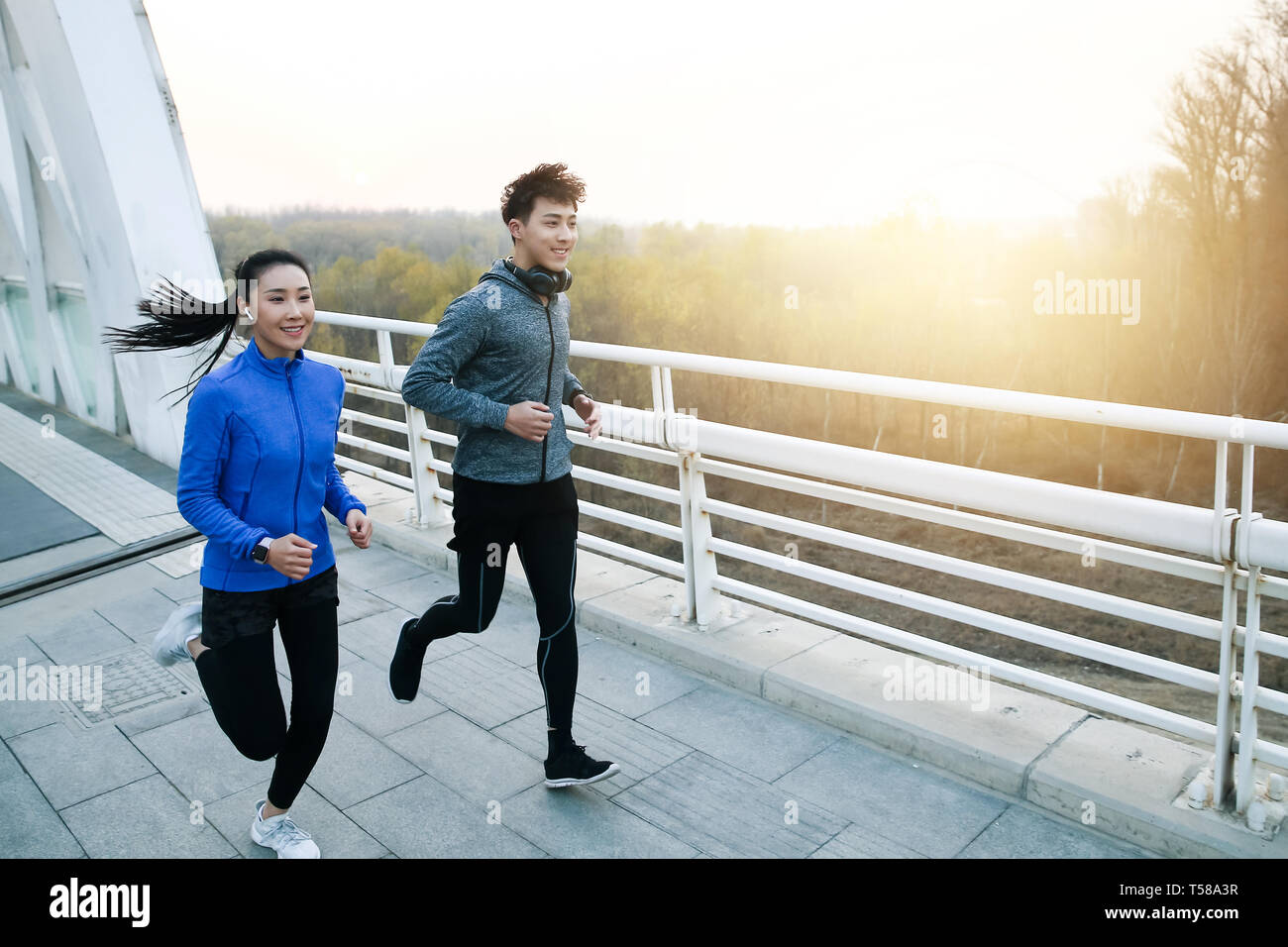 Young couples outdoor jogging Stock Photo - Alamy