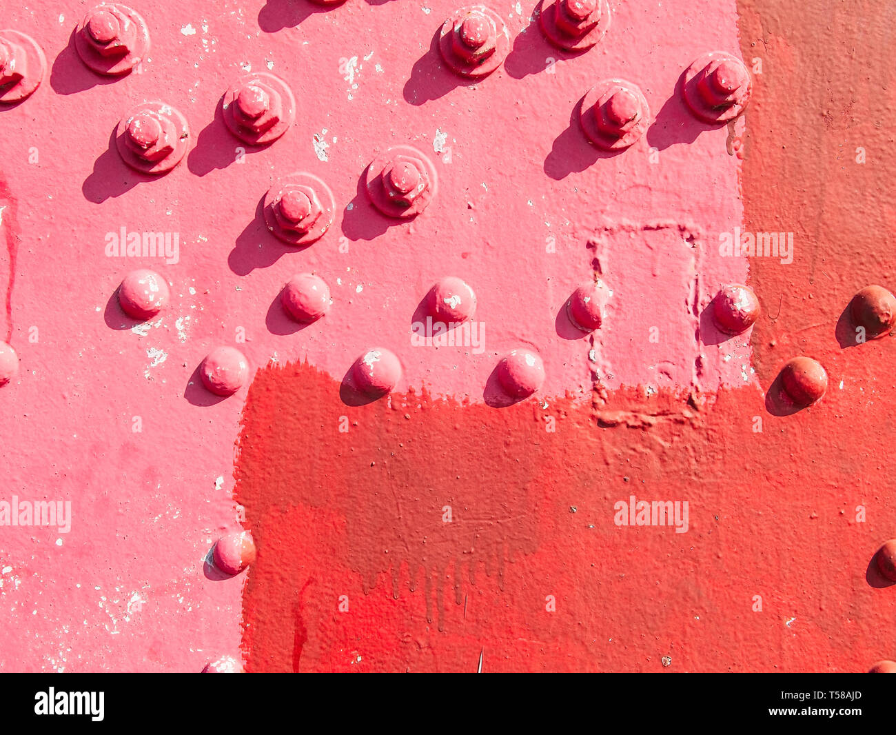 Close-up of steel surface with bolts and weathered red paint Stock ...