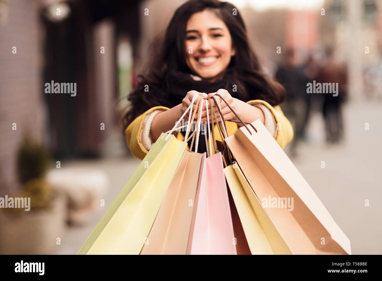 Woman stretching shopping bags hi-res stock photography and images - Alamy