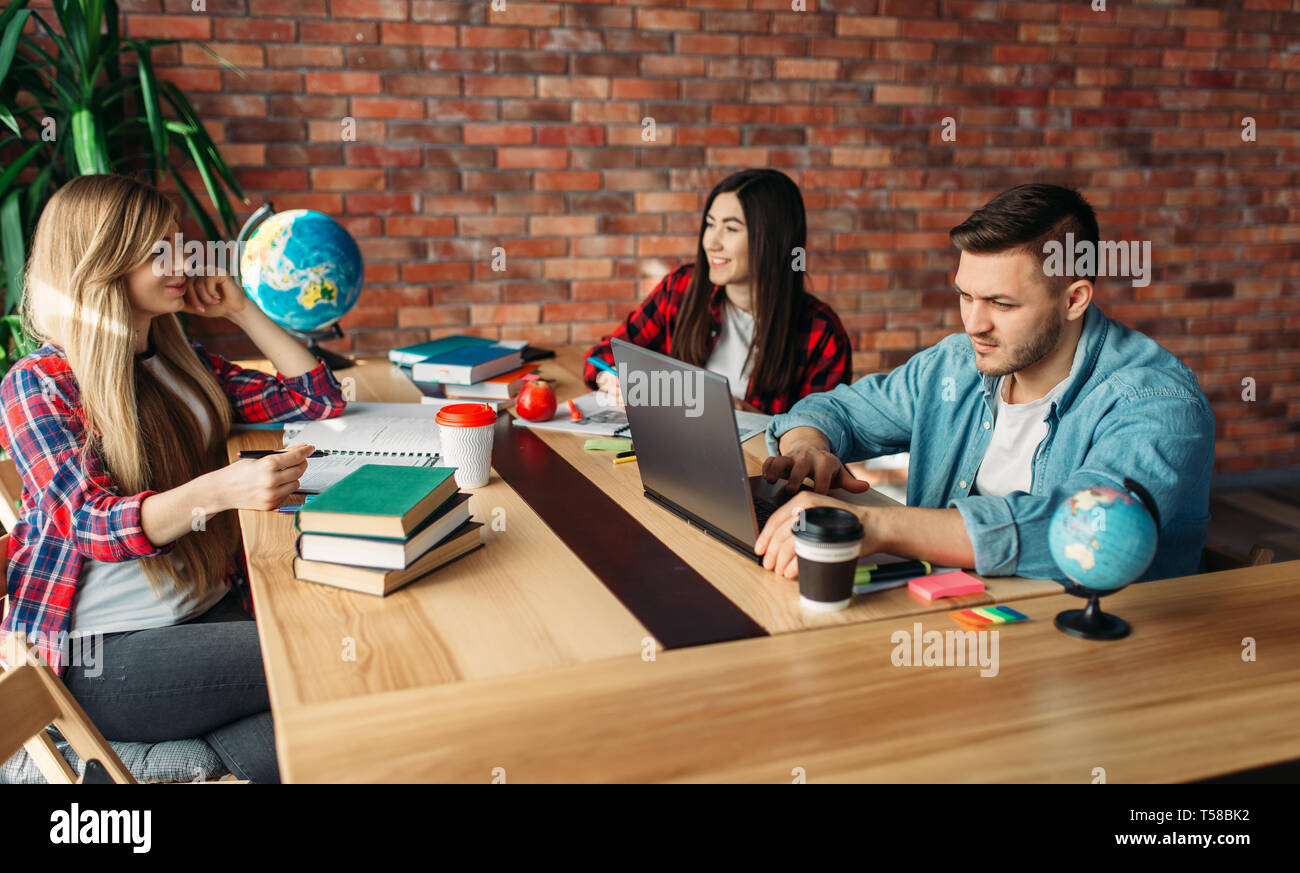 Group of students studying at the table together Stock Photo - Alamy