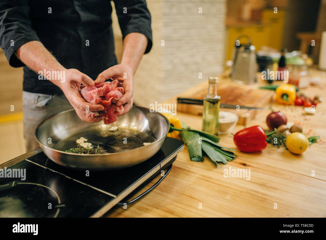 Man frying meat in pan hi-res stock photography and images - Alamy