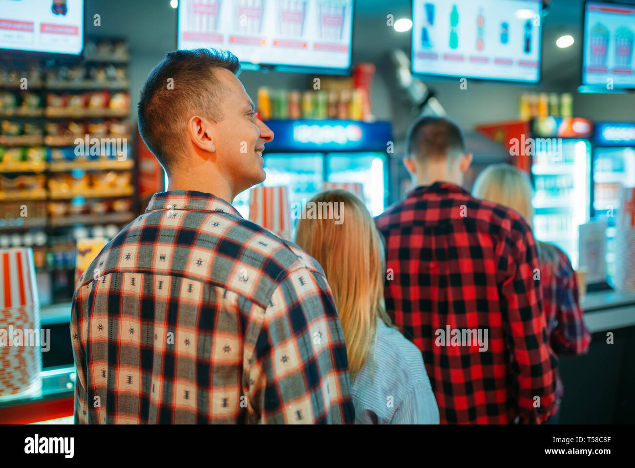 Audience choosing food in cinema bar Stock Photo - Alamy