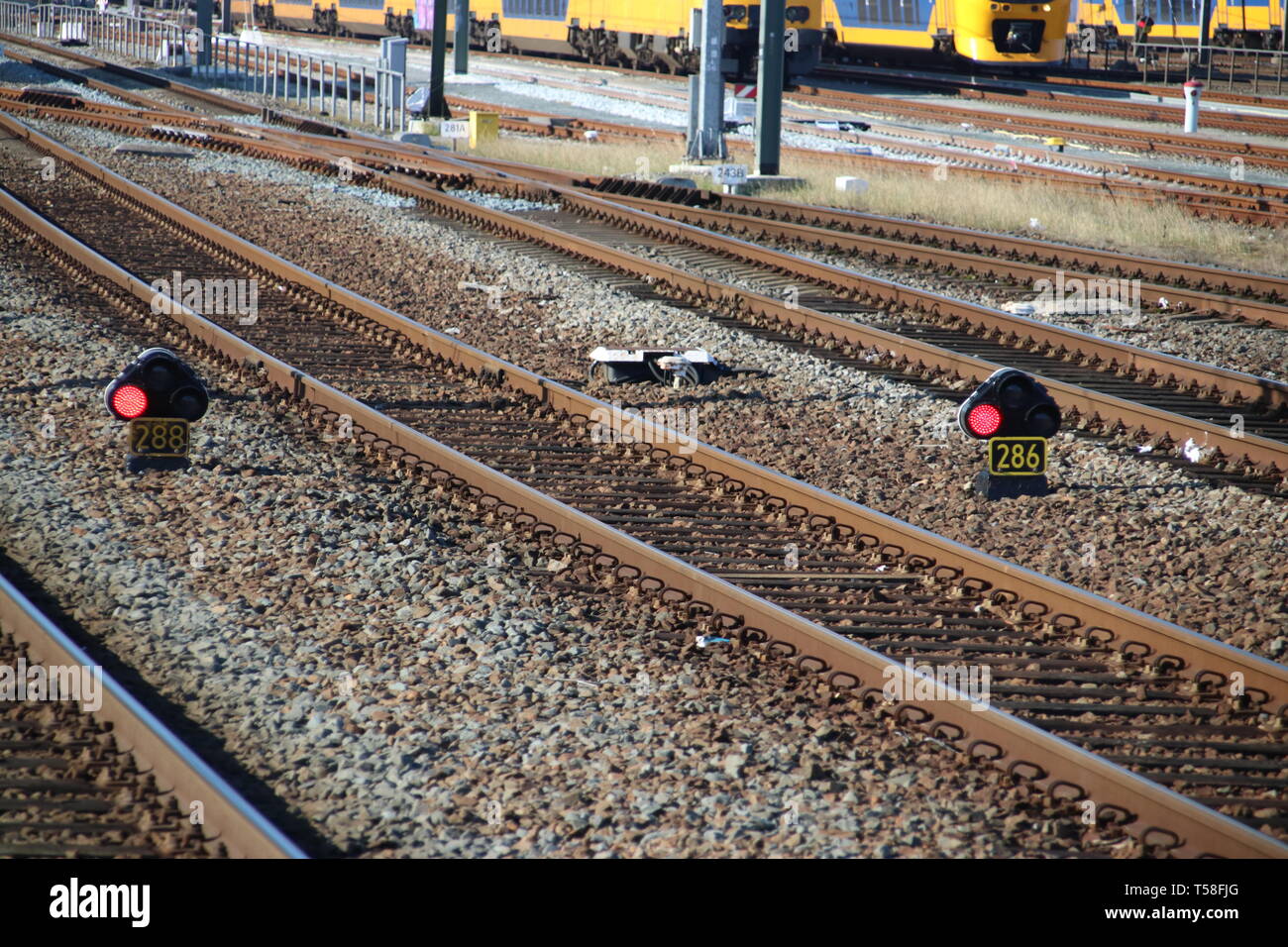 red signs between the railroad tracks at Rotterdam Central Station in ...