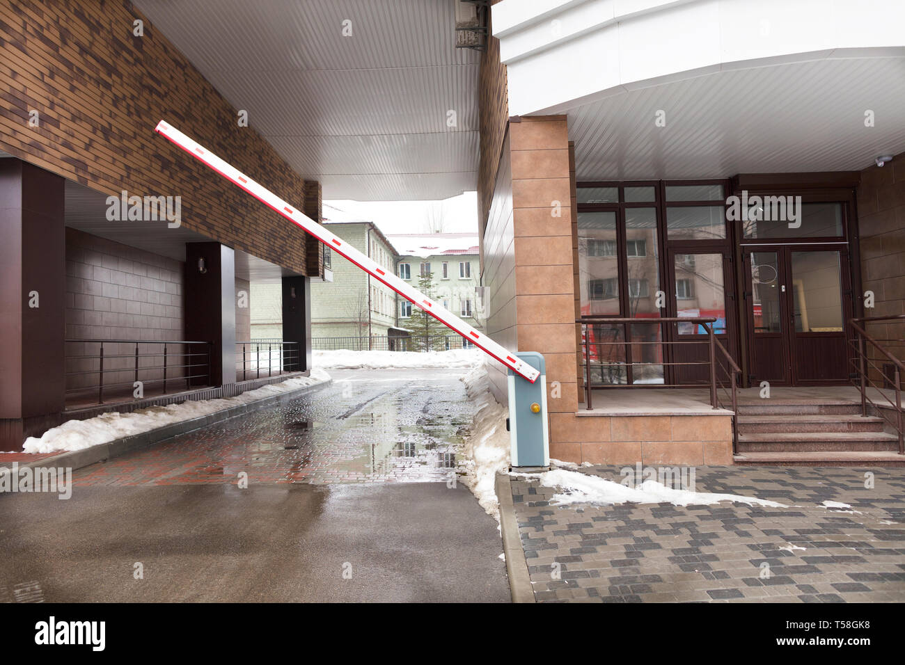 Automatic barrier gates to enter the courtyard of the building serve as ...