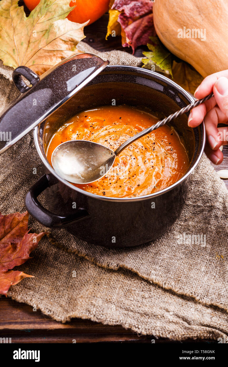 Photo of soup puree in saucepan, pumpkin on linen cloth Stock Photo - Alamy