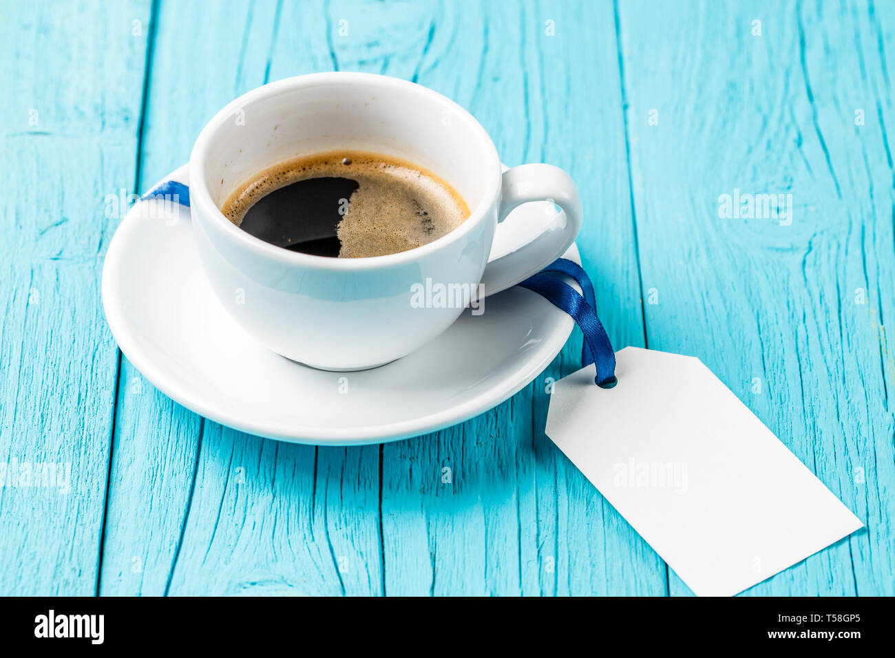 Cup of coffee with card Stock Photo - Alamy