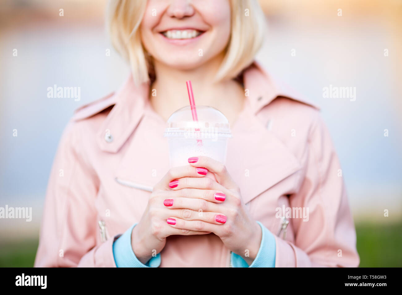 Portrait of blonde with milkshake Stock Photo - Alamy