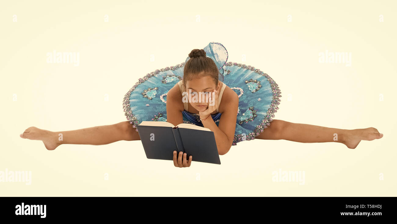 Girl ballerina stretching split while read book. Ballet career issues ...