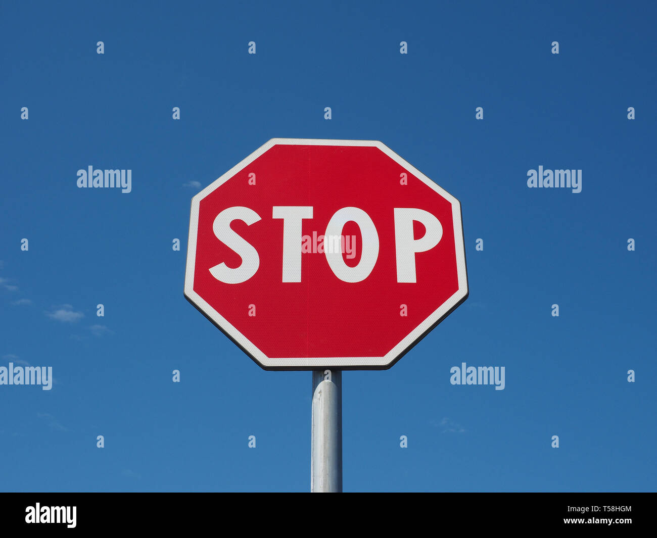 Warning signs, stop traffic sign over blue sky Stock Photo - Alamy