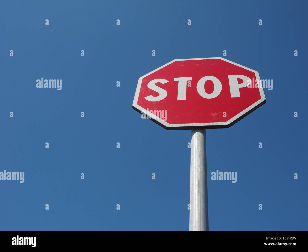 Warning signs, stop traffic sign over blue sky Stock Photo - Alamy
