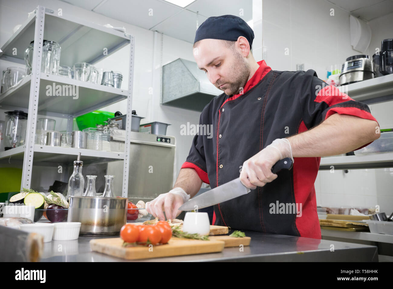 Restaurant kitchen. Chef about to cut the ingredients Stock Photo - Alamy
