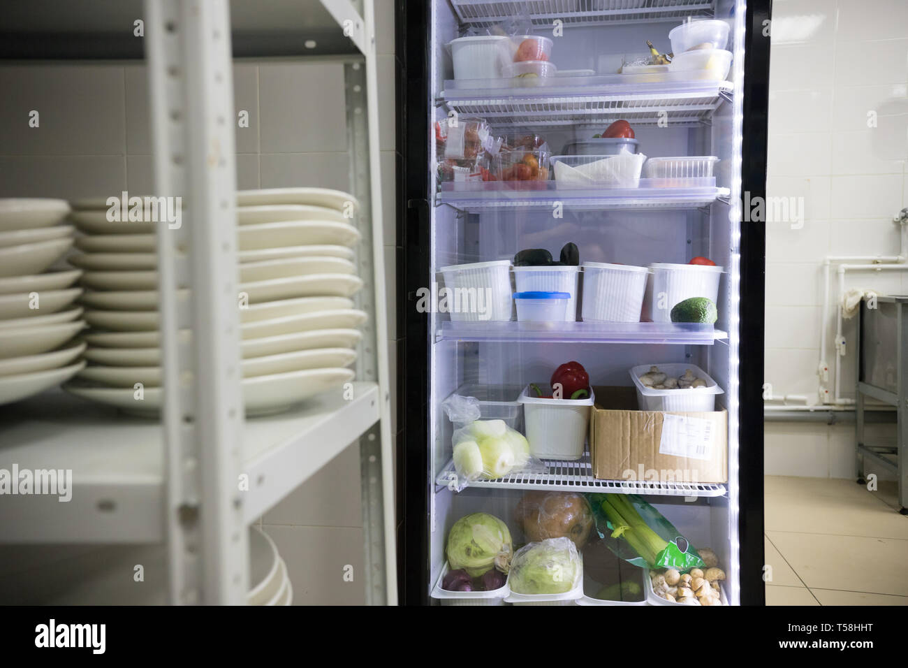 Restaurant kitchen. An opened fridge with products Stock Photo - Alamy