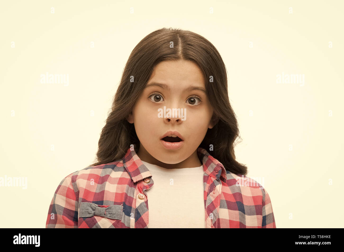 Girl with shocked look isolated on white. Little kid in casual style ...