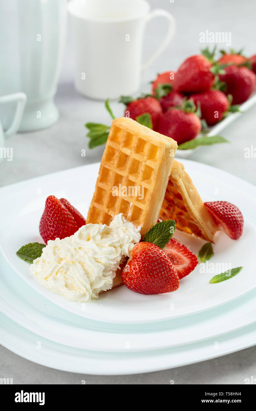 Waffles with strawberries and cream garnished with fresh mint Stock ...