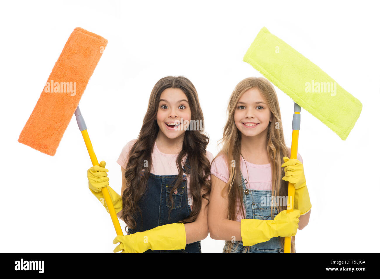 Adorable clean freaks. Cute girls holding mops for cleaning floor ...
