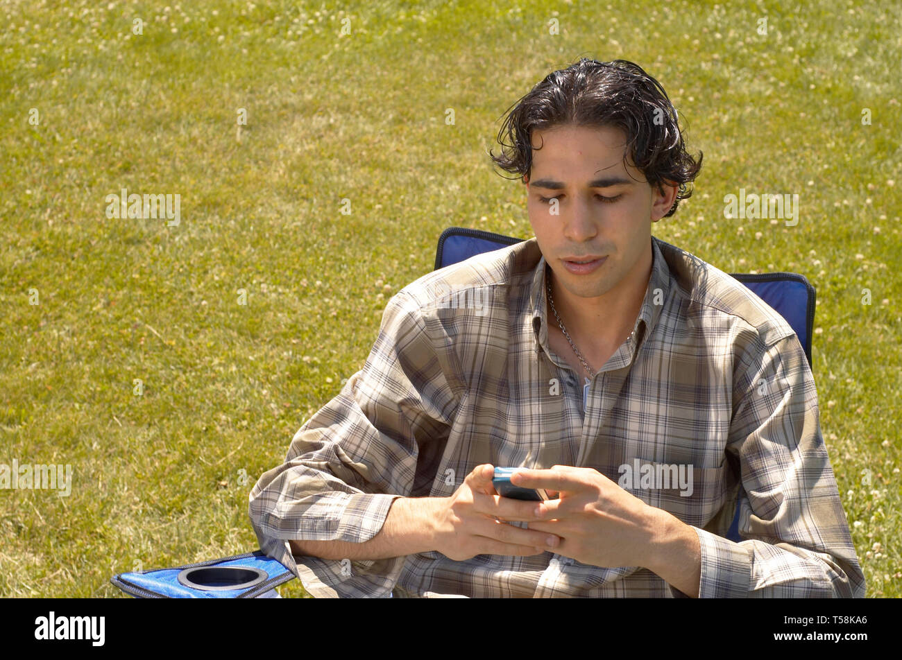 casual boy sending message with his mobile phone Stock Photo - Alamy