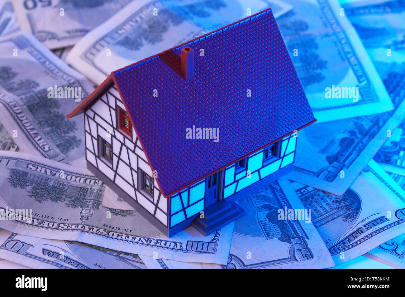 real estate concept with currency and house Stock Photo - Alamy