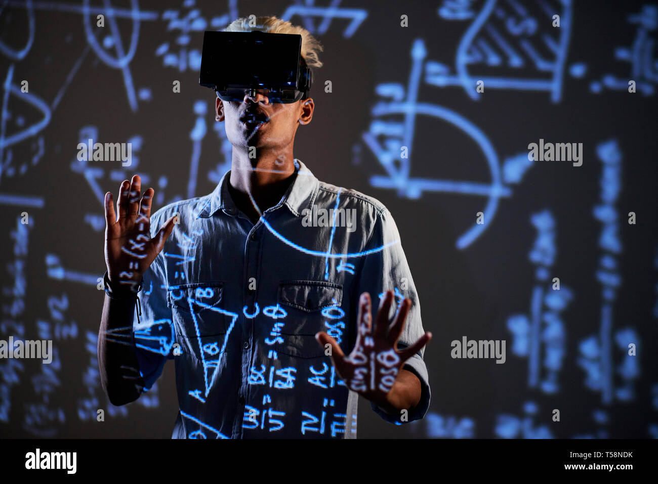 Curious student watching educational video on mathematics Stock Photo ...