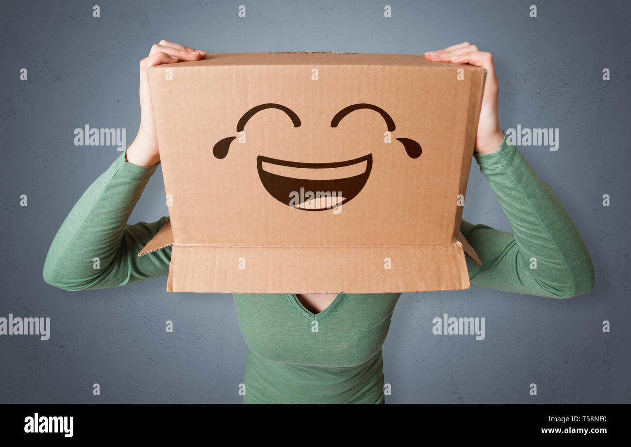 Funny woman wearing cardboard box on her head with smiley face Stock ...
