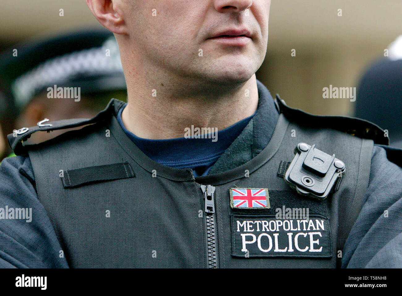 A policeman wearing a British flag on his chest whilst far right EDL ...