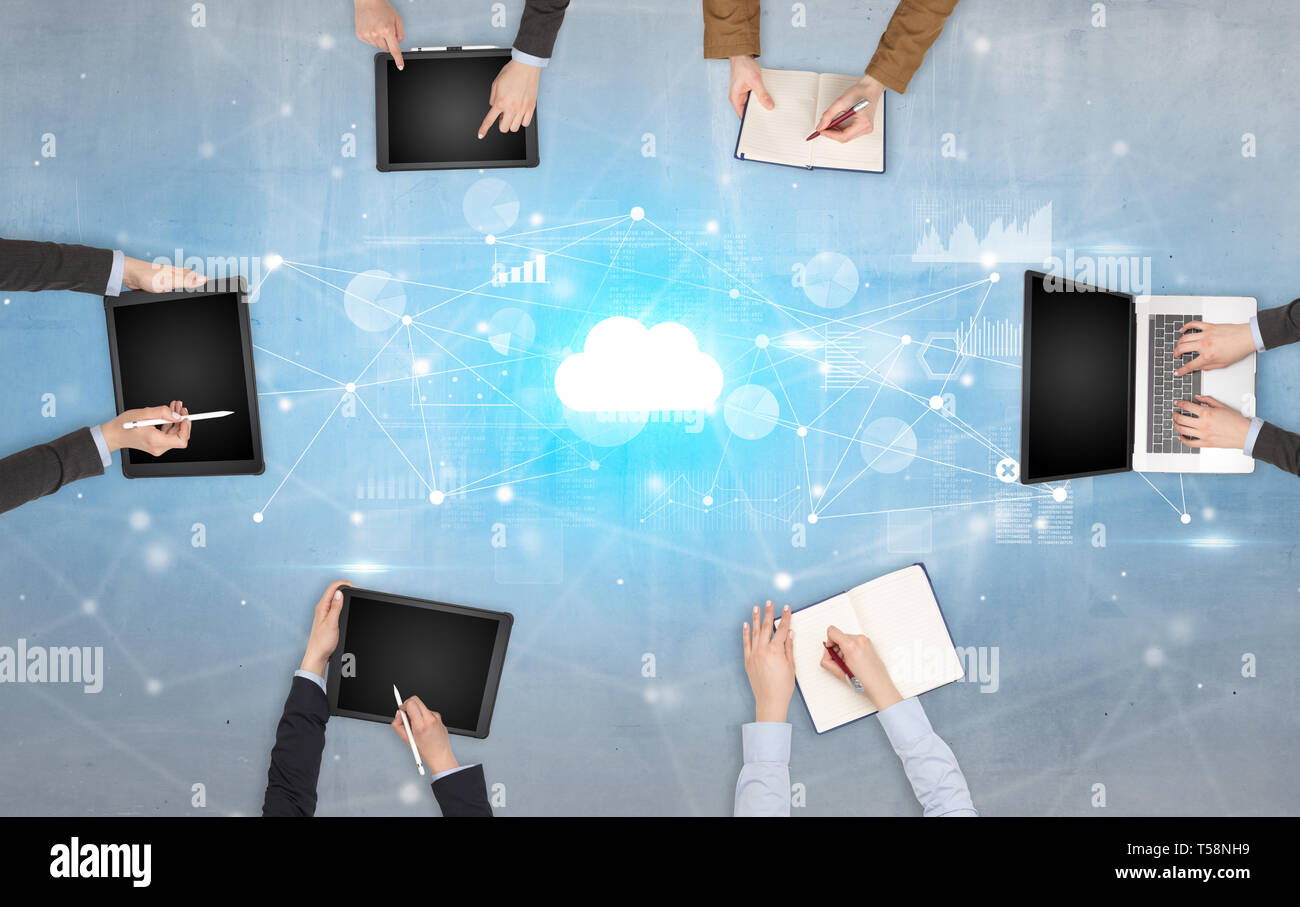 Group of people with devices in hands working on reports with online ...